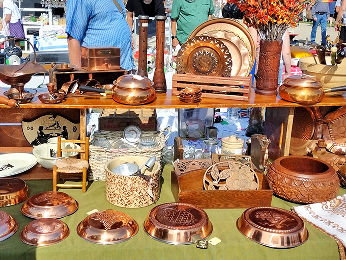 Copper gleams under the summer sun, each patina-kissed pot and pan whispering tales of Sunday dinners and holiday feasts from decades past.