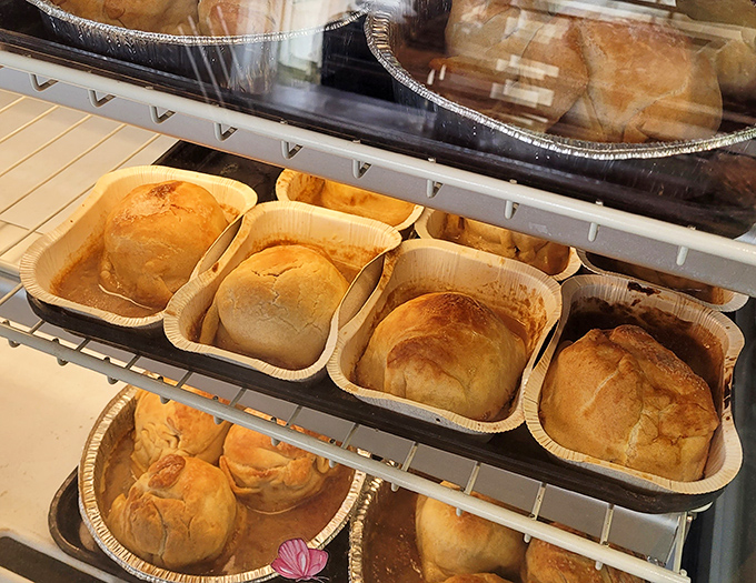 Golden-brown apple dumplings nestled in their wooden boats, sailing across a sea of sweet syrup toward your eager taste buds.