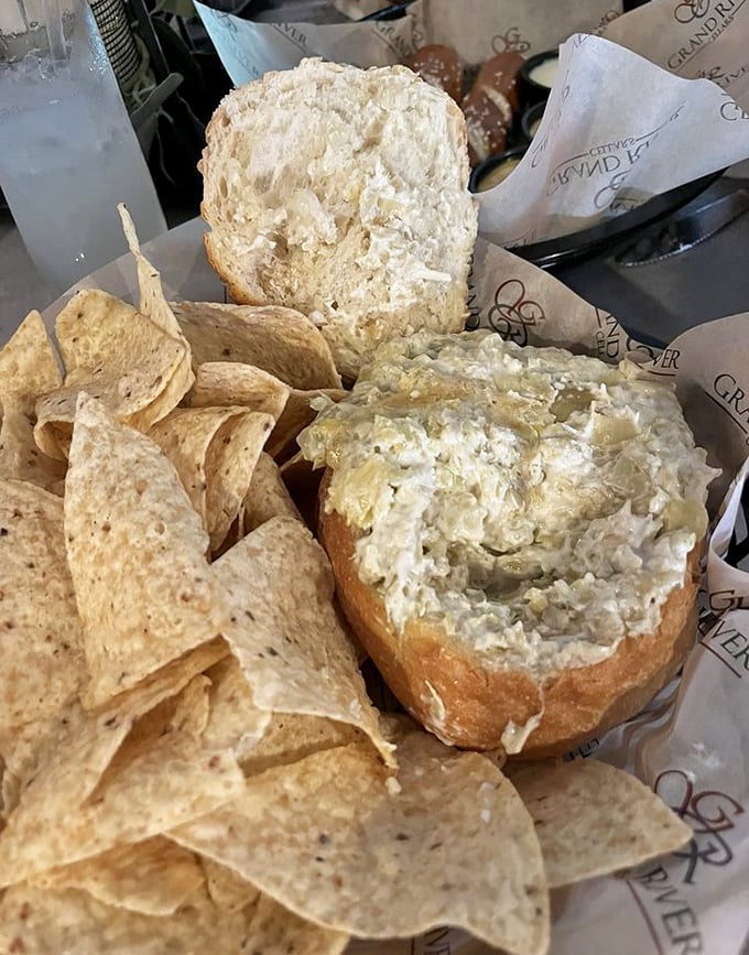 Artichoke dip that makes first dates memorable and family gatherings legendary. Served with warm bread and tortilla chips for double-dipping delight.