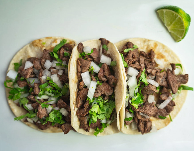 Behold the stars of our show – carne asada tacos in all their simple perfection. Three perfect bites of heaven with that essential lime wedge standing by.