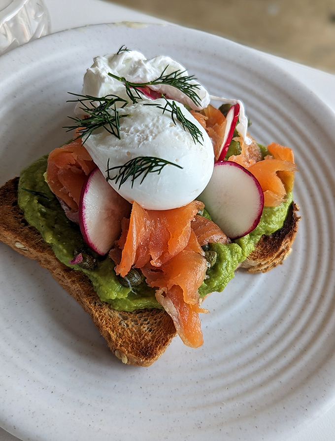 Not all avocado toast is created equal. This masterpiece with smoked salmon, poached egg, and radish slices might just change your breakfast religion.
