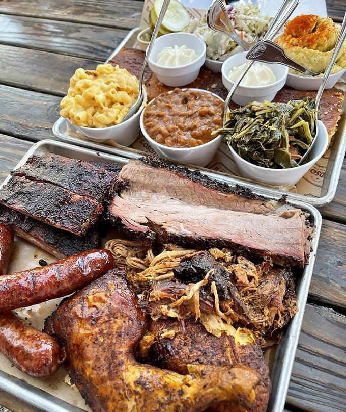 Behold the Texas Trinity in all its glory! Brisket with that perfect smoke ring, sides in their little white cups, and enough meat to make carnivores weep with joy.