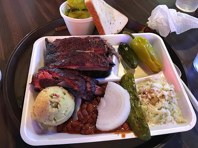 Behold the holy trinity: ribs with that perfect bark, beans that didn't come from any can, and slaw that knows its supporting role.