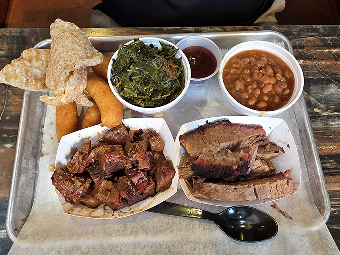 Barbecue nirvana on a metal tray. The smoke ring on that brisket is like nature's way of saying "you're welcome."