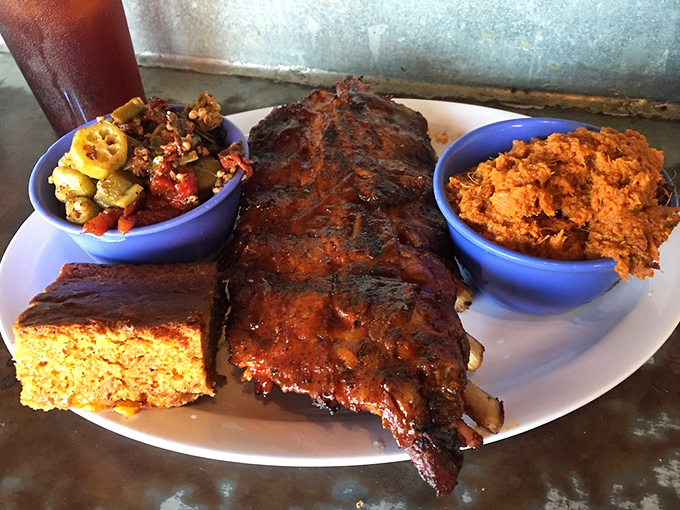 Behold the star attraction: baby back ribs with that perfect bark, cornbread that doesn't apologize for being delicious, and sides that demand respect.