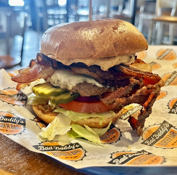 Behold the architectural marvel that is a Bad Daddy's burger&mdash;where bacon, beef, and veggies unite in a towering tribute to American ingenuity.