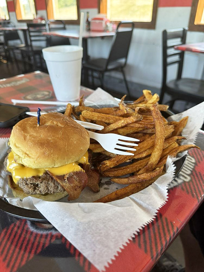 Burger perfection doesn't need fancy frills. This hand-formed patty topped with melted cheese and crispy bacon speaks the universal language of deliciousness.