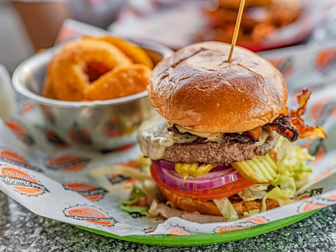 This isn't just a bacon cheeseburger; it's a towering monument to the art of excess, complete with onion rings standing guard.
