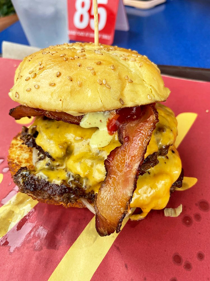 This isn't just a bacon cheeseburger; it's a towering monument to excess done right. The melty cheese cascade is practically hypnotic.