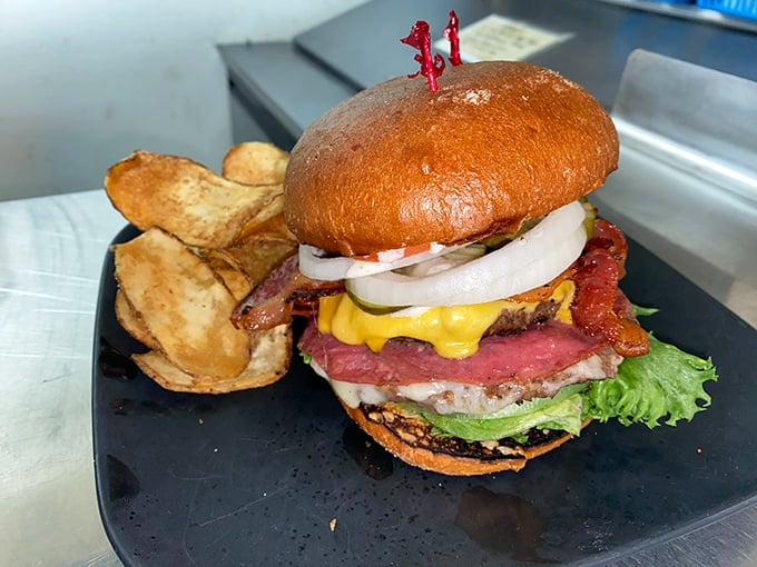 This isn't just a burger; it's an architectural masterpiece of beef, bacon, and cheese that requires both hands and zero shame.