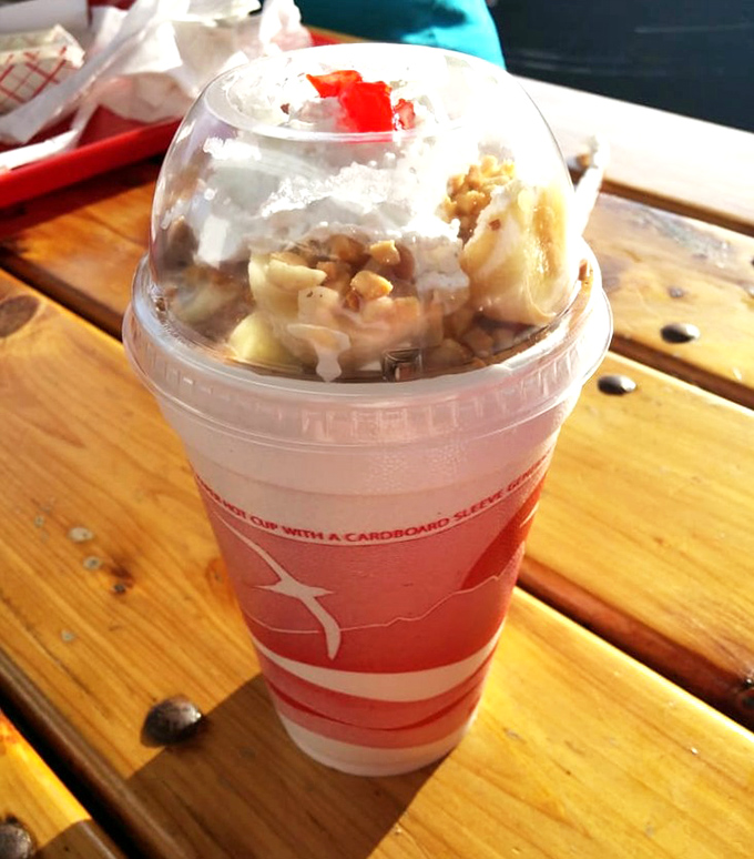The banana boat in a cup: proof that sometimes the best things in life come in plastic containers on wooden picnic tables.