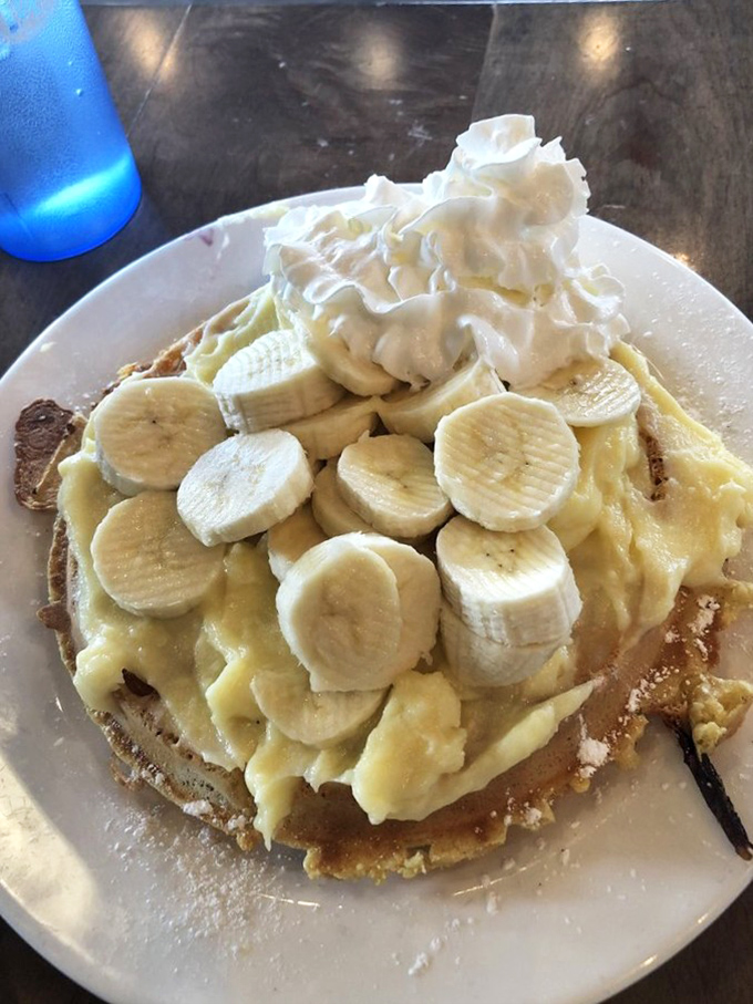 Banana cream waffle paradise! This mountain of fresh fruit and whipped cream turns breakfast into a celebration worthy of song.