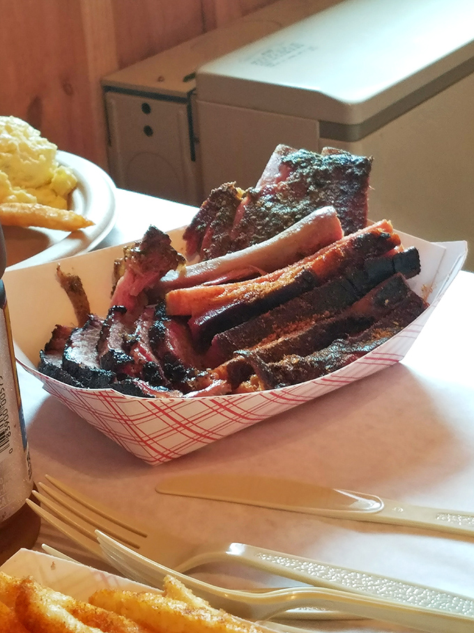 These ribs aren't just smoked, they're transformed&mdash;each glistening, bark-crusted piece tells a story of patience, fire, and time-honored technique.
