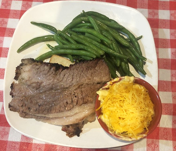 Brisket that doesn't need Instagram filters. That smoke ring tells the story of hours in the smoker, while those green beans provide the illusion of healthful balance.