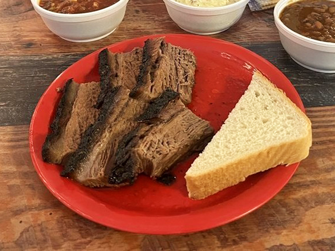 Behold the brisket in all its bark-crusted glory, where each slice tells the story of patience, smoke, and barbecue mastery.