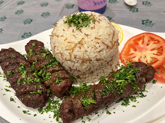 Perfectly grilled beef kababs that would make any carnivore weak at the knees. The fragrant rice mountain and fresh herbs elevate this dish from simple to sublime.