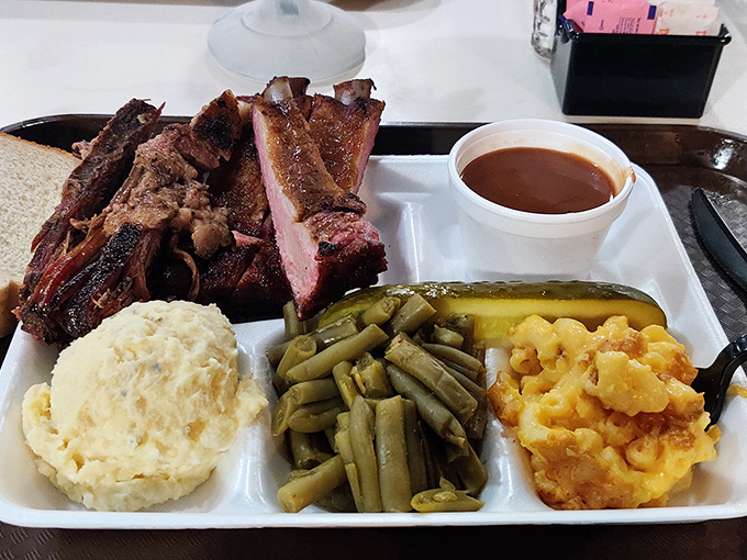 Behold the holy trinity of Texas barbecue: perfectly smoked ribs, sides that don't apologize for being sides, and sauce that knows its place.