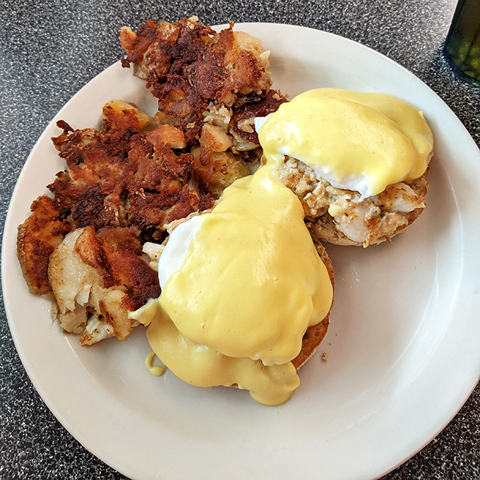 Behold the star of our show: Eggs Benedict with a golden hollandaise blanket so perfect it deserves its own security detail.