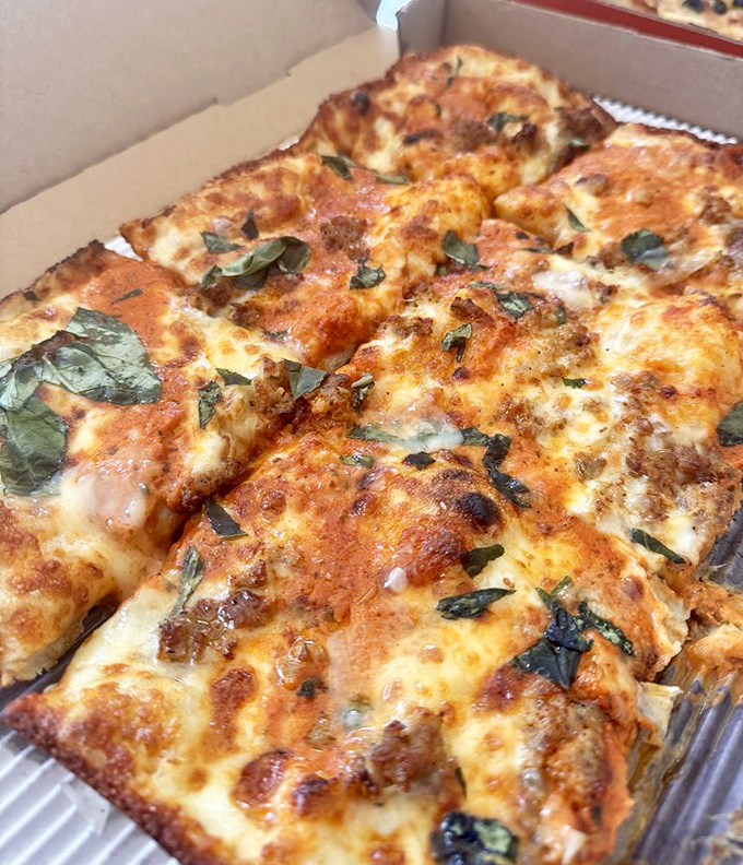 This isn't just pizza&mdash;it's a geometric masterpiece of perfectly charred squares, fresh basil, and cheese that stretches like it's training for the Olympics.