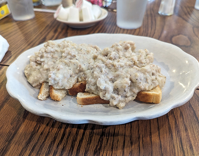 Behold the star attraction &ndash; creamy sausage gravy cascading over golden toast. Comfort food that doesn't need Instagram filters to look irresistible.