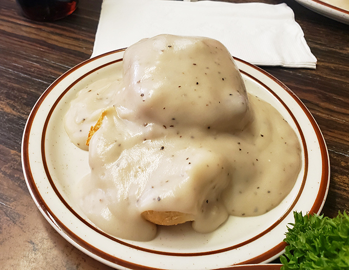 These biscuits and gravy aren't just breakfast&mdash;they're a spiritual experience. That pepper-flecked gravy blankets the biscuit like a warm hug.