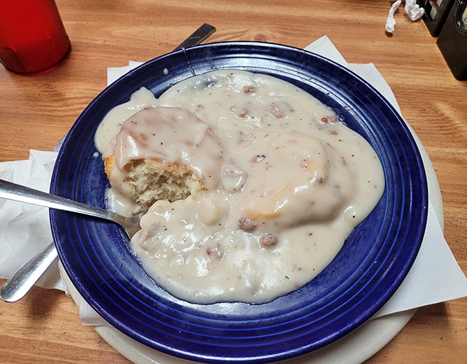 Behold the holy grail of Southern comfort: fluffy biscuits drowning in creamy sausage gravy that'll make you question everything.