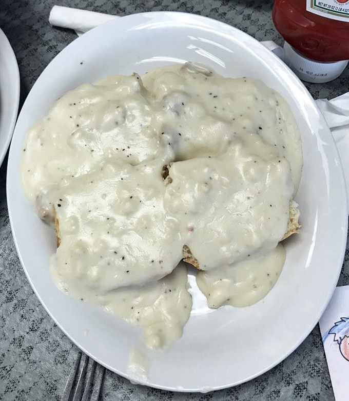 Behold the holy grail of comfort food—biscuits smothered in peppery sausage gravy so good you'll contemplate ordering seconds before finishing firsts.
