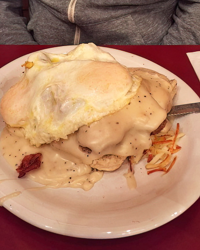 Behold the holy grail of breakfast indulgence&mdash;eggs and creamy gravy cascading over a mountain that proves biscuits can indeed be life-changing.