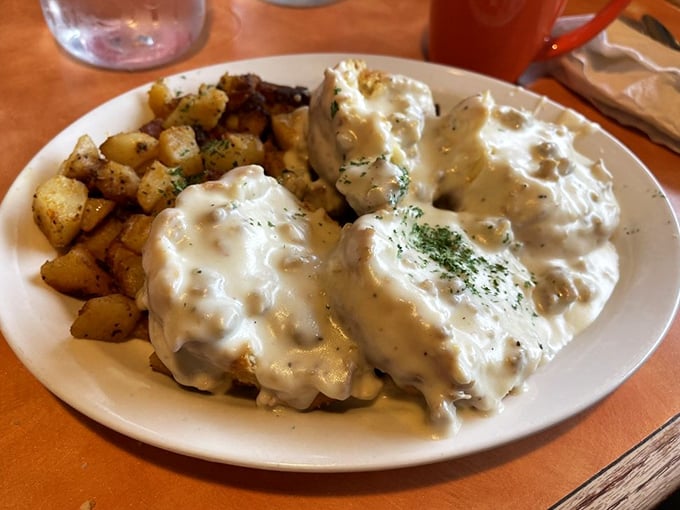 Biscuits and gravy that would make your Southern grandmother weep with joy, served with potatoes that clearly went to finishing school.