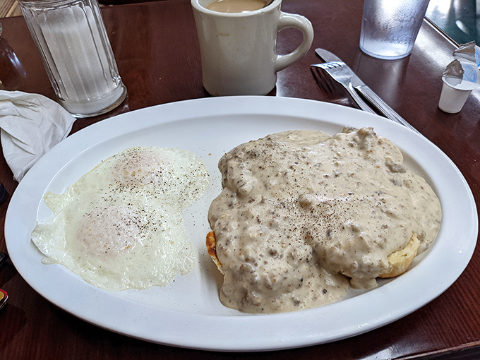 Behold: the holy grail of Southern breakfast. That pepper-speckled gravy cascading over a golden biscuit is what dreams are made of.