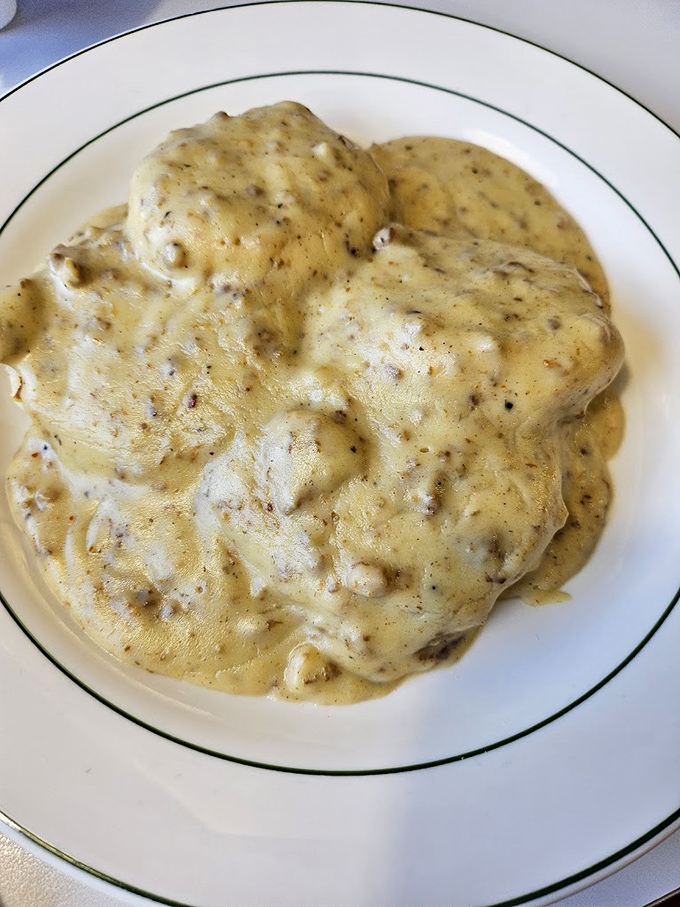 Behold the crown jewel &ndash; biscuits smothered in peppery sausage gravy so good it should require a permission slip. This plate alone justifies the invention of breakfast.