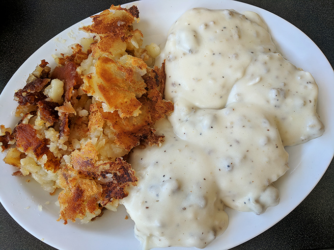 Behold the star attraction: homemade sausage gravy alongside perfectly crisped home fries. This plate alone has launched countless dawn pilgrimages across Ohio.