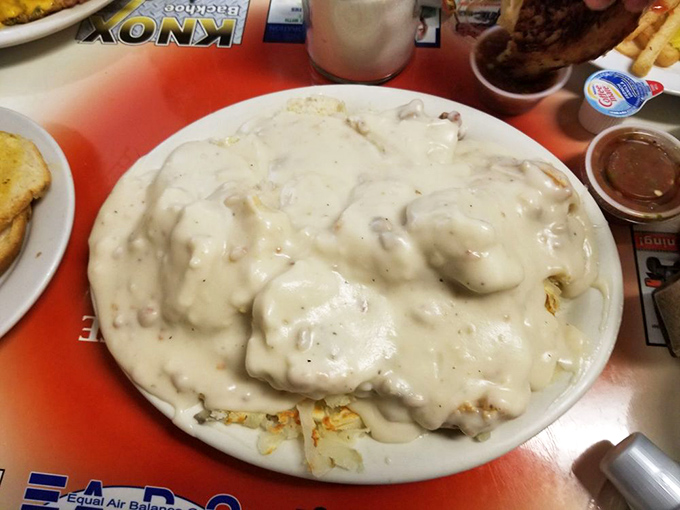 Behold the star attraction: biscuits and gravy so generously portioned you might need air traffic control to navigate through this cloud of comfort.