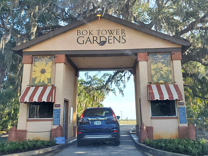 Bok Tower Gardens welcomes visitors through this charming entrance. Your car might be modern, but you're about to step into a timeless botanical paradise.