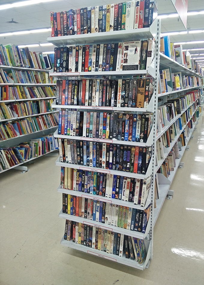 Books and DVDs stacked like a library that threw caution to the wind. One person's abandoned "Titanic" DVD is another's movie night salvation.