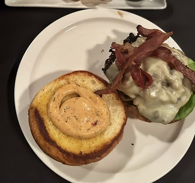 Meet the legendary Bourbon Burger—a half-pound masterpiece topped with bacon, smoked gouda, and that bourbon sauce that haunts your dreams long after the last bite.