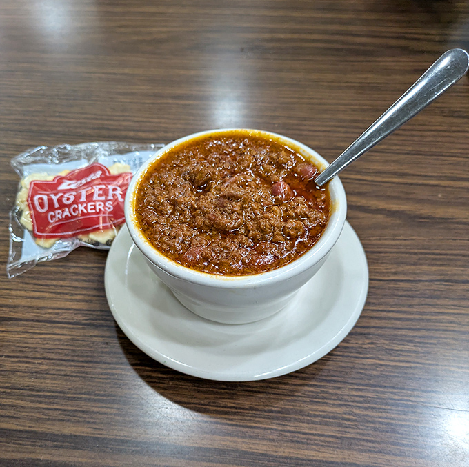 The legendary chili arrives like a warm handshake in a bowl, with those signature oyster crackers standing by for their supporting role.