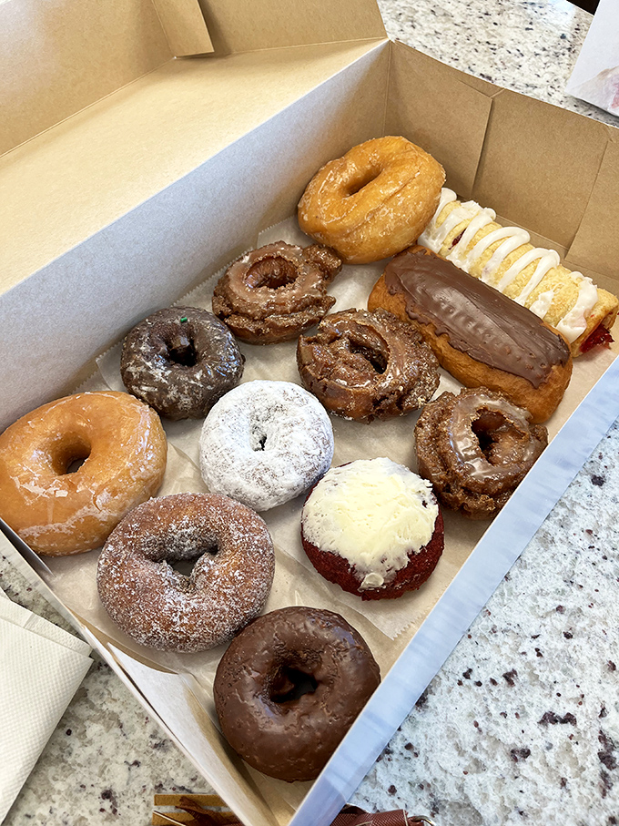 Donut heaven in cardboard form. This box contains more happiness than most people experience in an entire workweek.