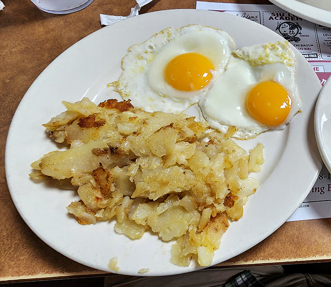 Sunny-side up eggs with perfectly crispy home fries&mdash;the breakfast equivalent of a warm hug. Simple food done right never goes out of style.