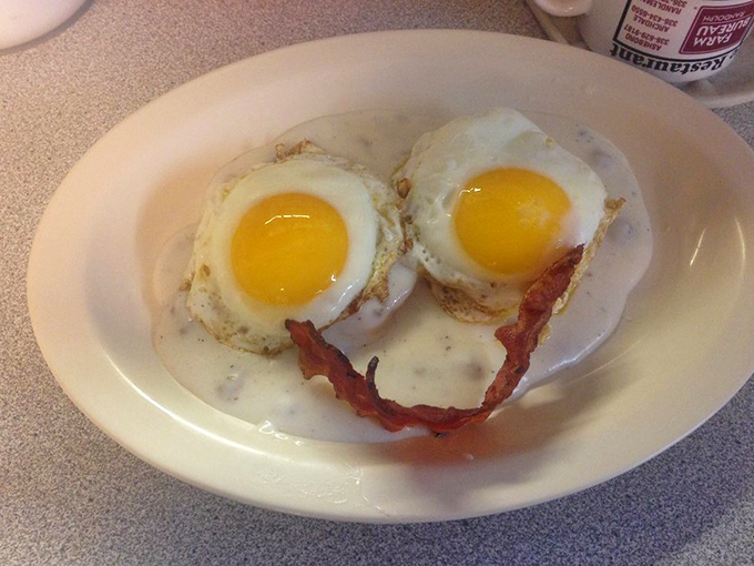 Sunny-side up perfection with bacon smiling back at you. These eggs aren't just cooked&mdash;they're performing a masterpiece on your plate.