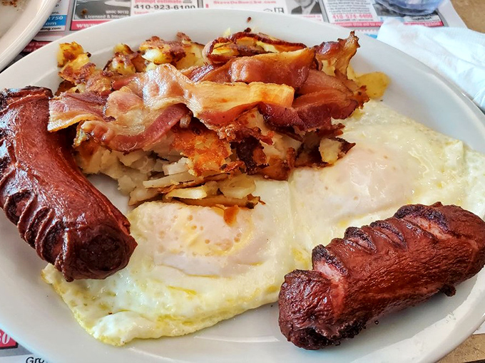 Breakfast nirvana achieved: perfectly cooked eggs, sausage links that snap just right, and home fries that could make a potato farmer weep with pride.