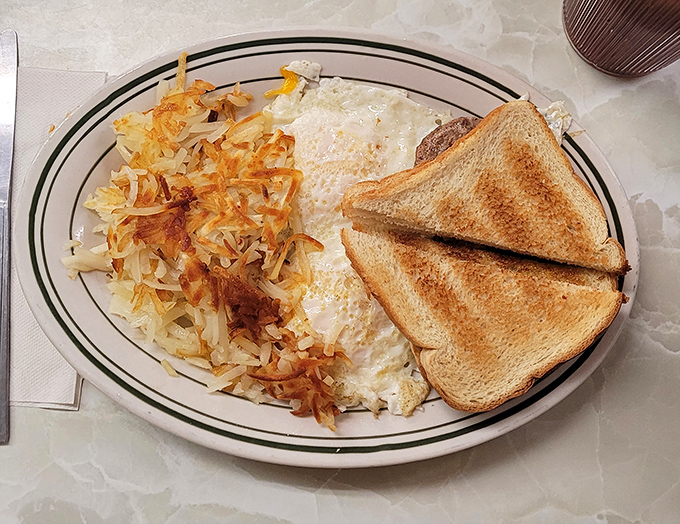 Eggs, hash browns, and toast: the holy trinity of breakfast done right. Simple perfection that makes you wonder why anyone bothered inventing avocado toast.