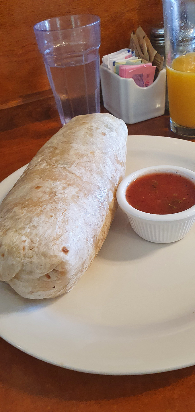 This breakfast burrito isn't just a meal, it's an edible sleeping bag stuffed with morning goodness. The side of salsa adds just the right wake-up call.