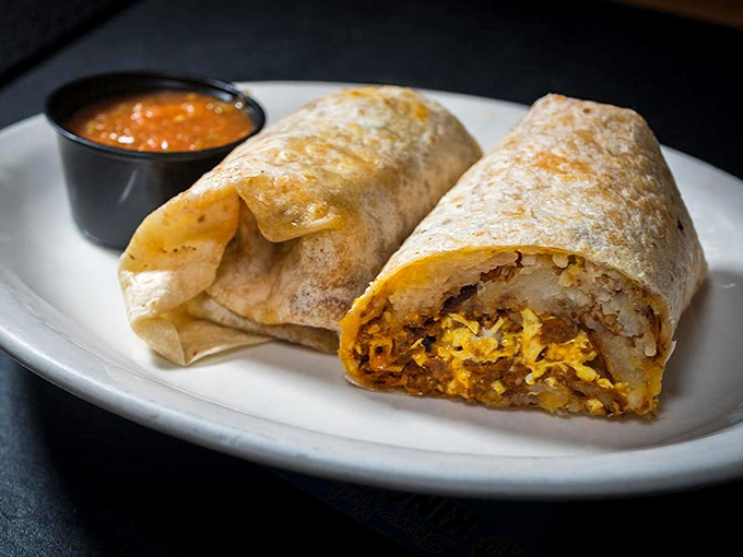 Behold the breakfast burrito in its natural habitat &ndash; perfectly grilled, stuffed with morning essentials, and accompanied by salsa that kicks your taste buds into high gear.