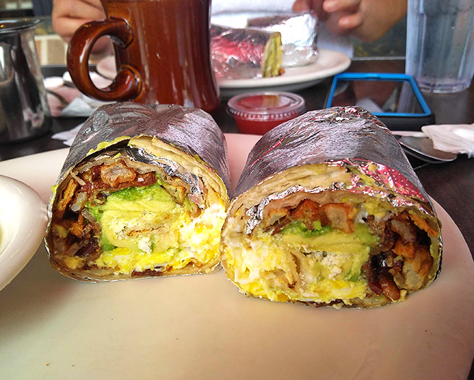 Behold the breakfast burrito in its natural habitat—cross-sectioned to reveal that perfect egg-to-filling ratio. This is edible architecture at its finest.