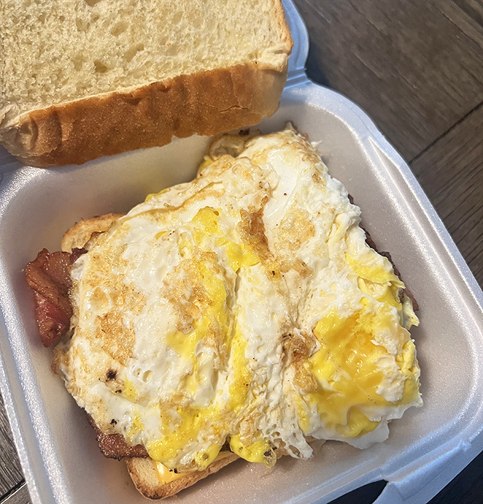 Breakfast perfection doesn't need fancy plating—just perfectly cooked eggs with molten yolks, crispy bacon, and toast that's actually toasted by a human being.