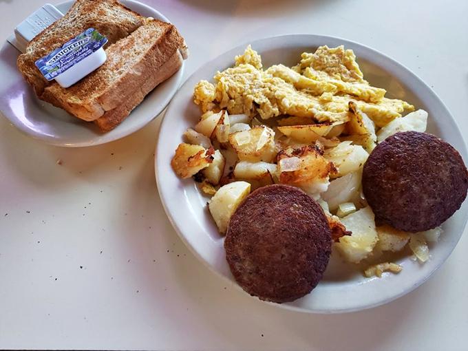 Breakfast alchemy at its finest: golden scrambled eggs, home fries with that perfect crisp-tender balance, and scrapple that would make any Marylander misty-eyed.