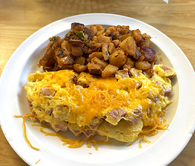 This ham and cheese omelet with home fries isn't just breakfast &ndash; it's edible therapy that costs less than a session with your therapist.