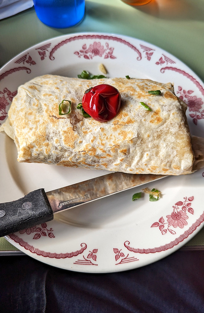 This breakfast burrito isn't just wrapped, it's embraced &ndash; a golden-grilled tortilla hugging eggs, beans, and cheese with the tenderness of a morning hug.