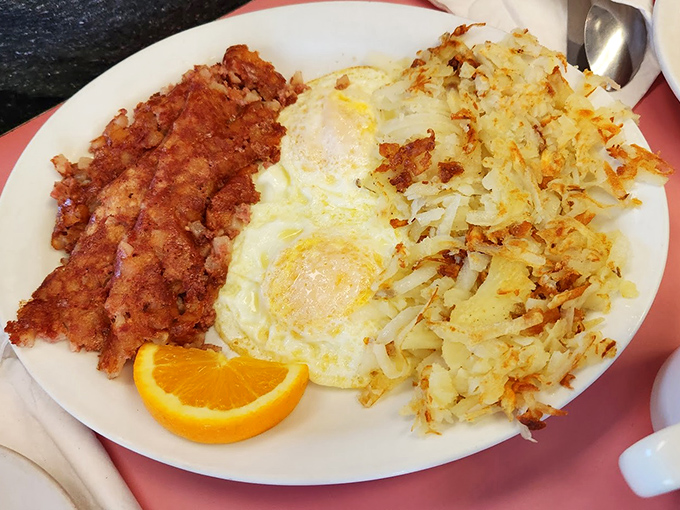 Sunny-side up eggs flanked by crispy hash browns and corned beef hash&mdash;a breakfast alliance so perfect it deserves its own national holiday.